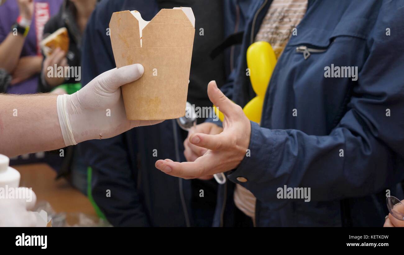 Hands putting take-out food container, close-up. Food delivery. Close ...