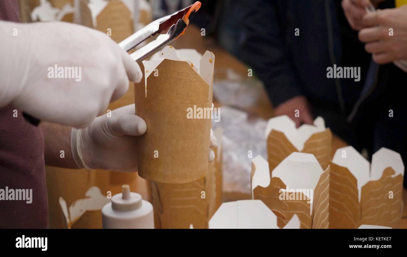Hands putting take-out food container, close-up. Food delivery. Close ...