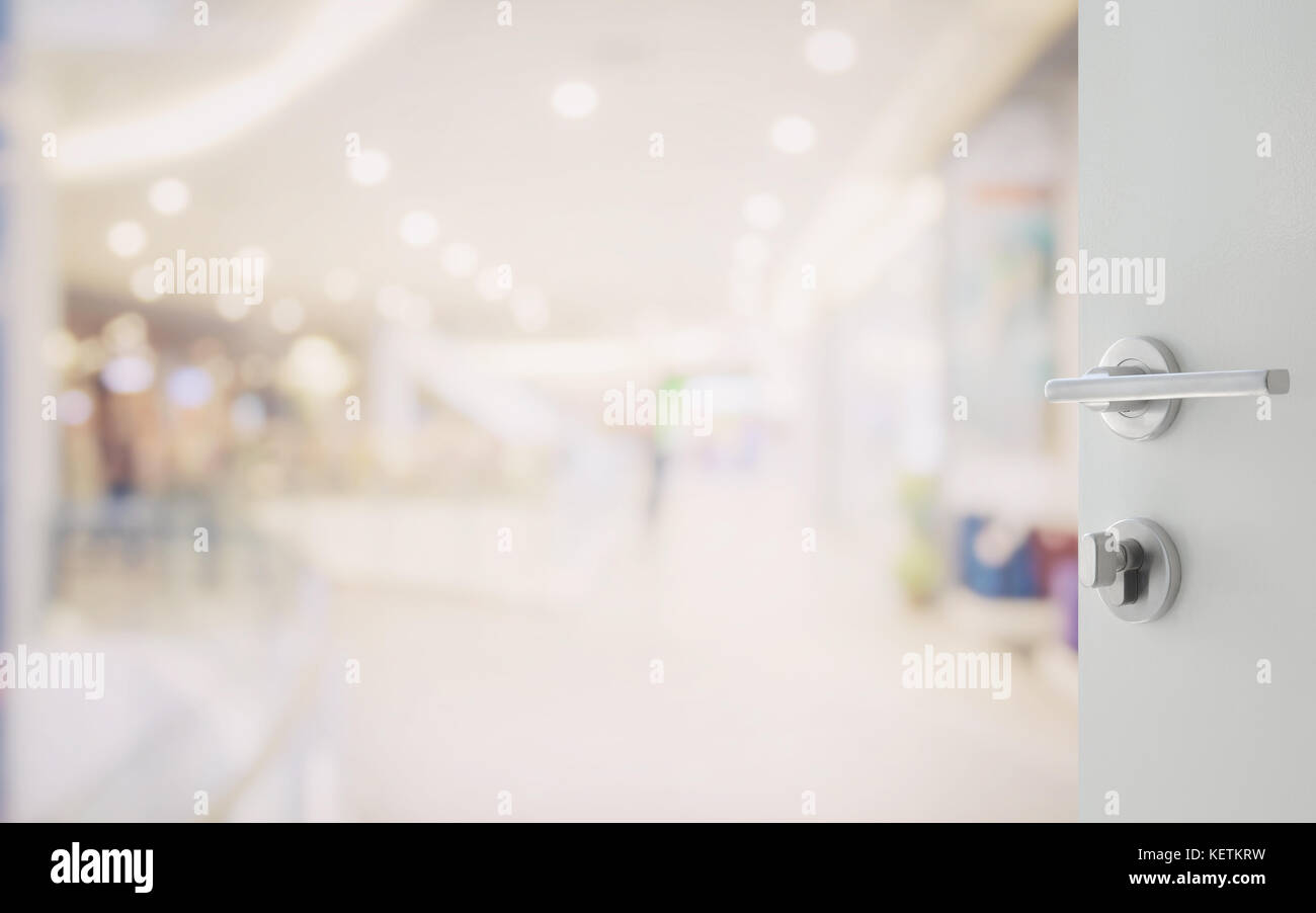 opened white door to shopping mall interior with bokeh as background ...