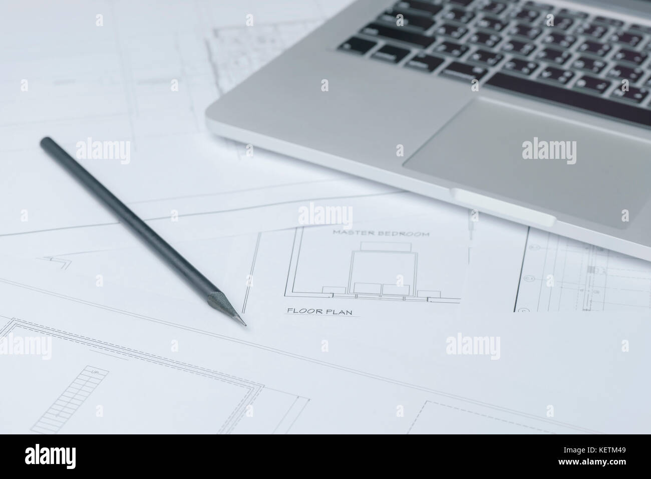 black pencil and computer laptop on architectural drawing paper for ...