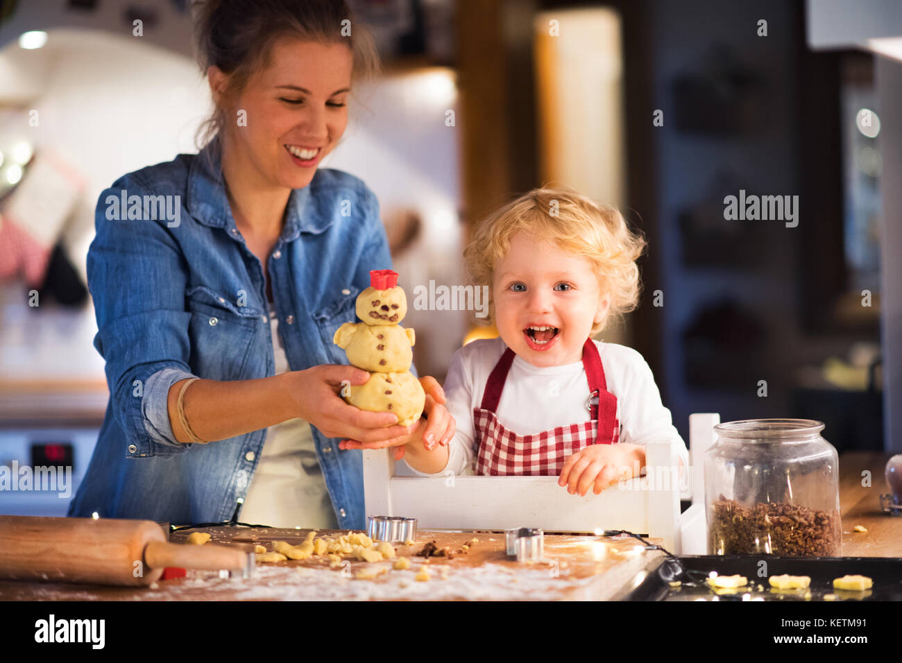 Young family making cookies at home Stock Photo - Alamy