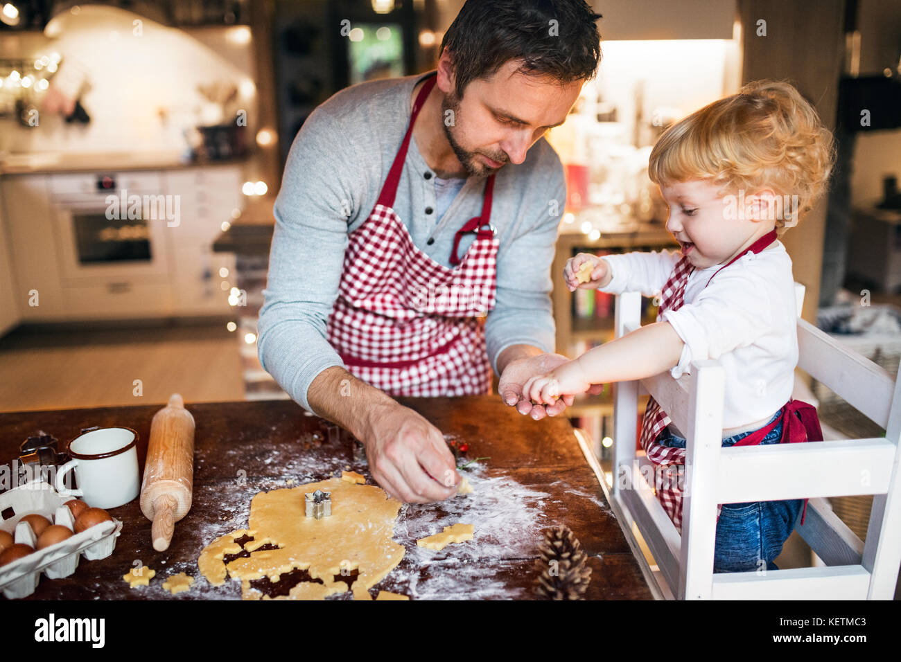 Young family making cookies at home Stock Photo - Alamy