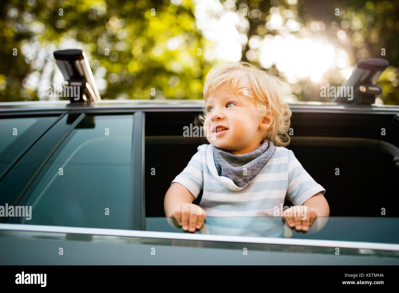 Little boy playing in the car, leaning out of window Stock Photo - Alamy