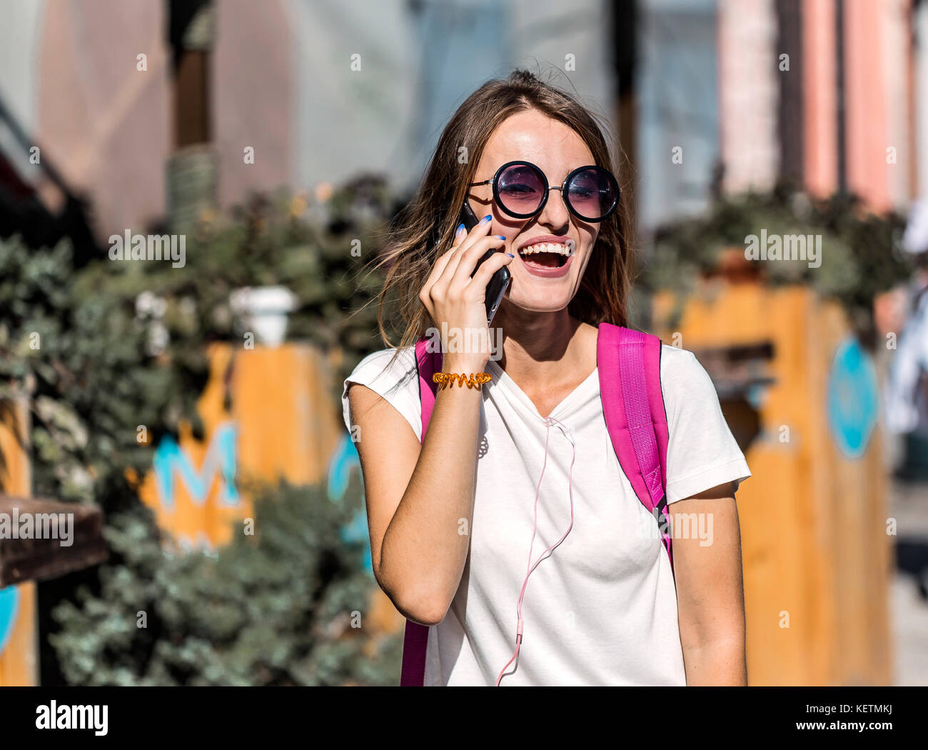 Happy Tourist Girl Talking on the Phone Stock Photo - Alamy