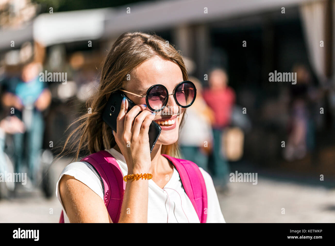 Happy Tourist Girl Talking on the Phone Stock Photo - Alamy