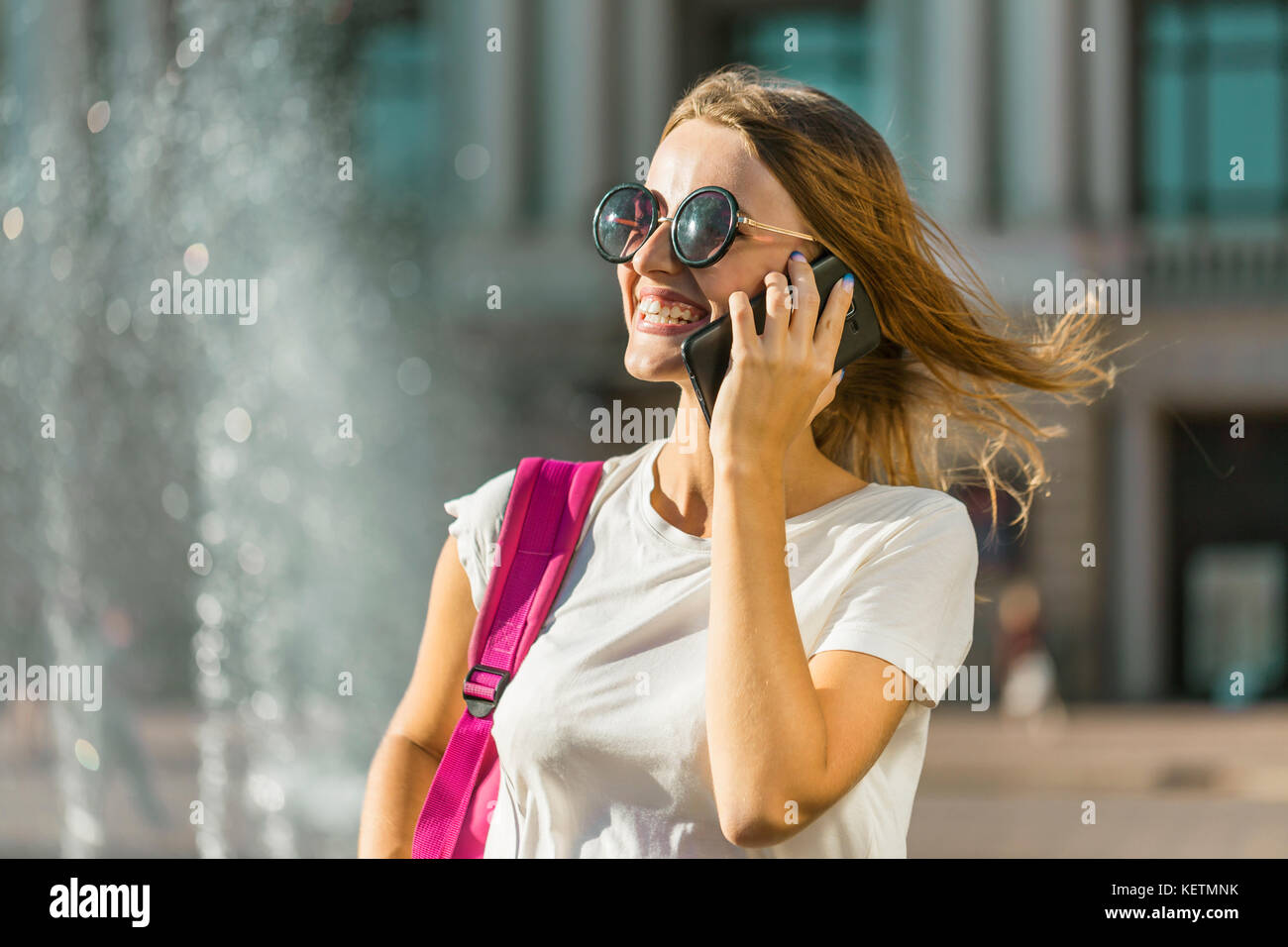 Happy Tourist Girl Talking on the Phone Stock Photo - Alamy