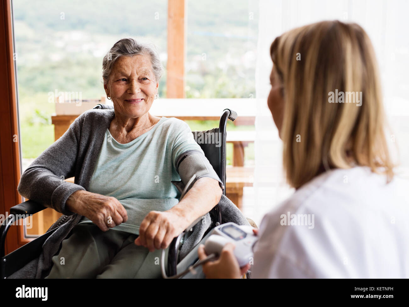 Health visitor and a senior woman during home visit Stock Photo - Alamy