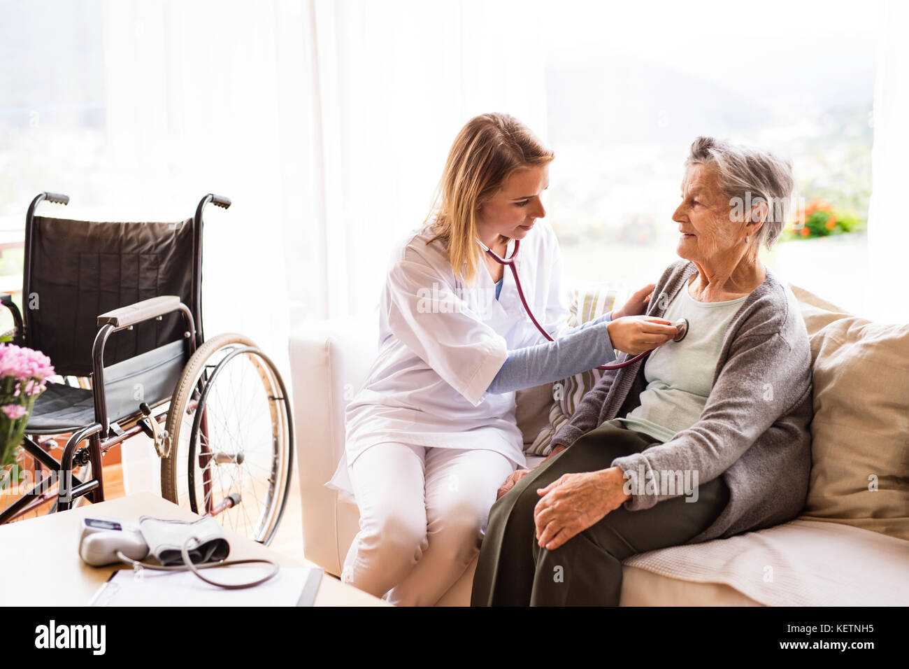 Health visitor and a senior woman during home visit Stock Photo - Alamy