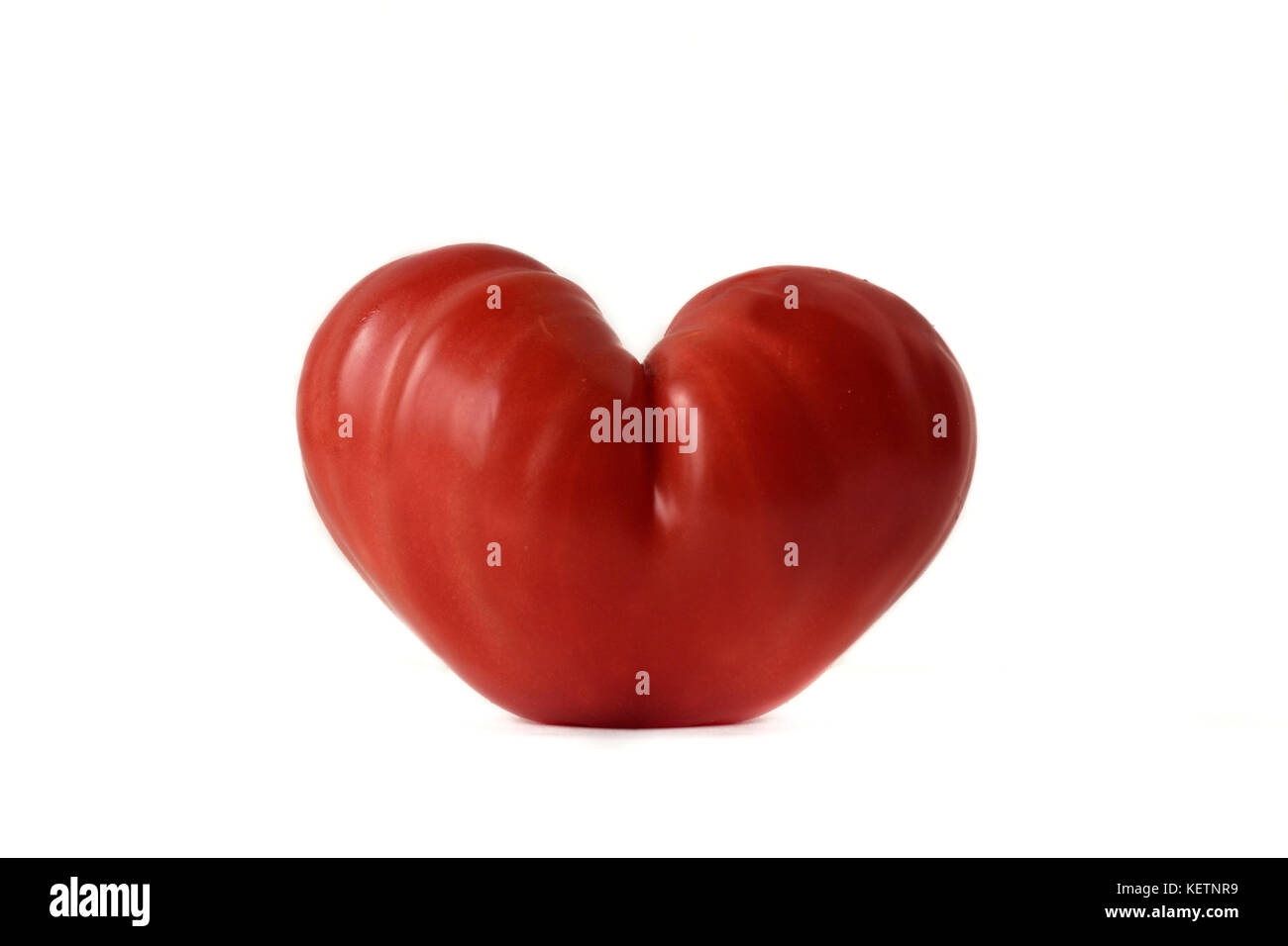 Heart shaped tomato on white background- Love concept Stock Photo - Alamy