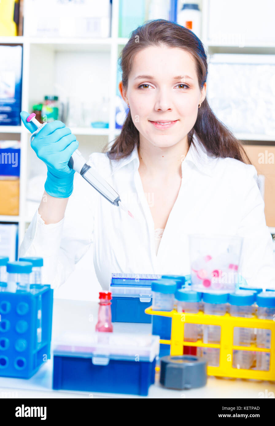 Female technician doing science experiment Stock Photo - Alamy