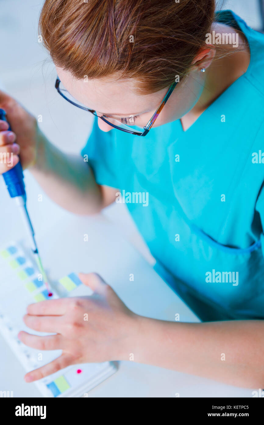 Nurse doing medical analysis Stock Photo - Alamy