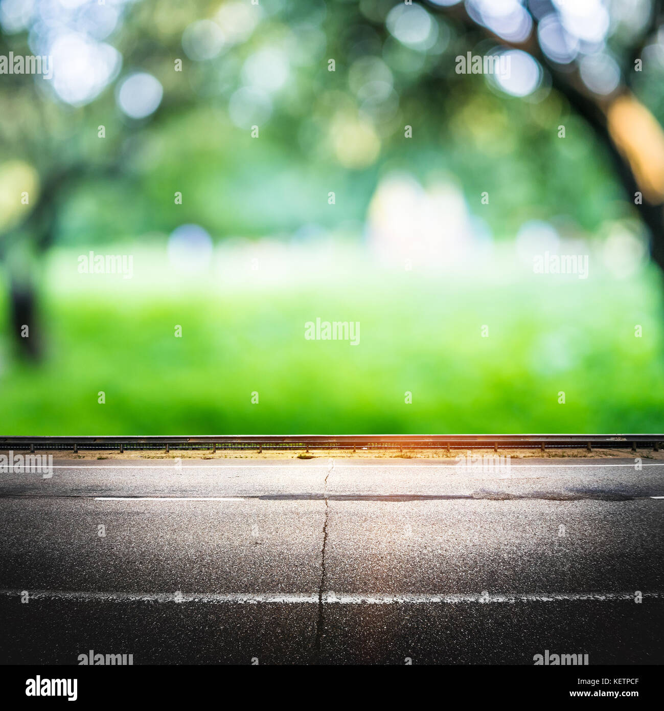 Green forest road background. Asphalt and blurred park Stock Photo - Alamy