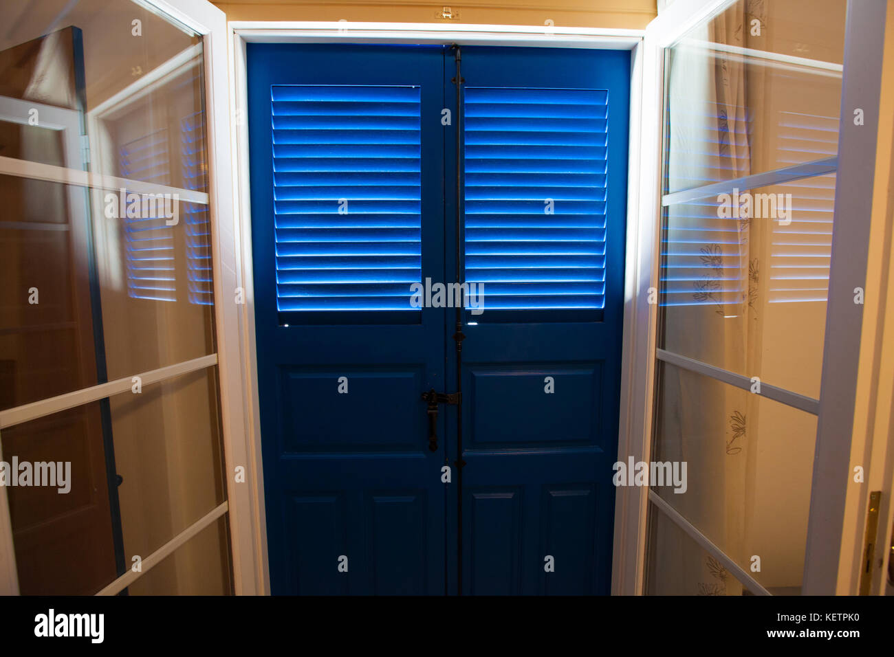 Blue door and window with shutters Stock Photo - Alamy