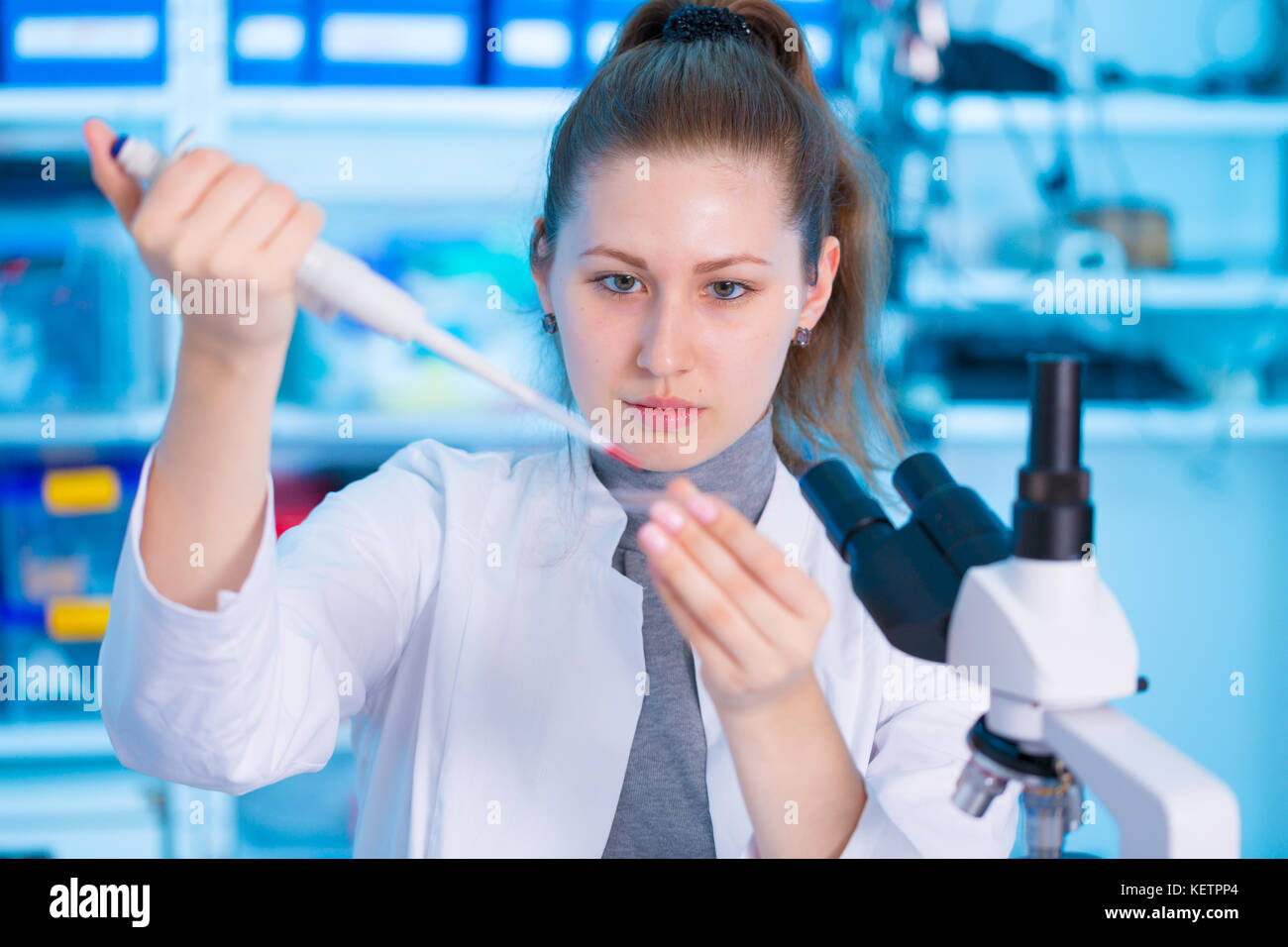 laboratory female assistant with pipette Stock Photo - Alamy