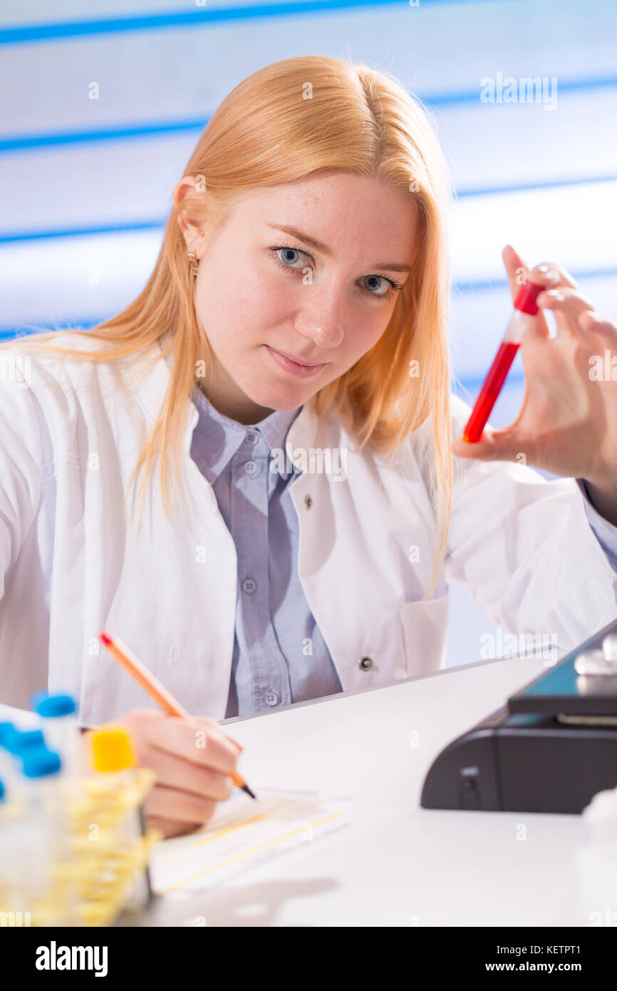 Female laboratory assistant with blood test for AIDS Stock Photo - Alamy