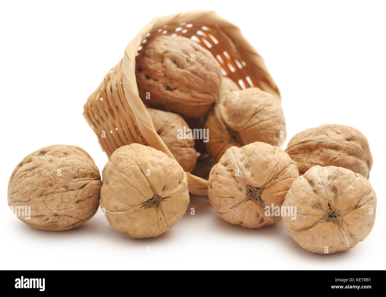 Walnut in a basket isolated over white background Stock Photo - Alamy