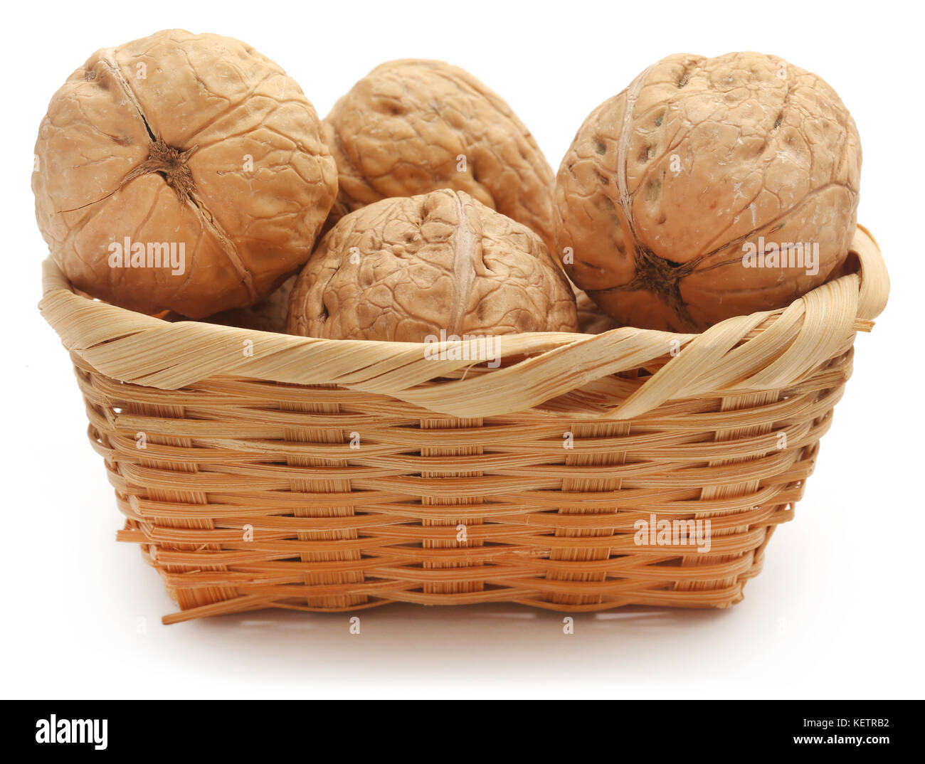 Walnut in a basket isolated over white background Stock Photo - Alamy