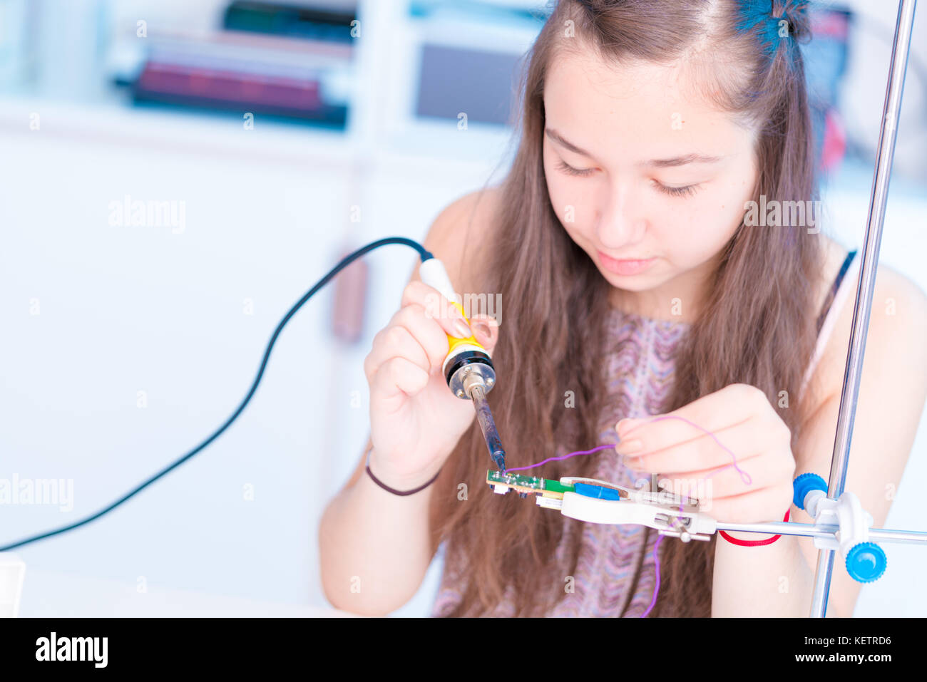 Schoolgirl in electronics class uses a soldering iron Stock Photo - Alamy