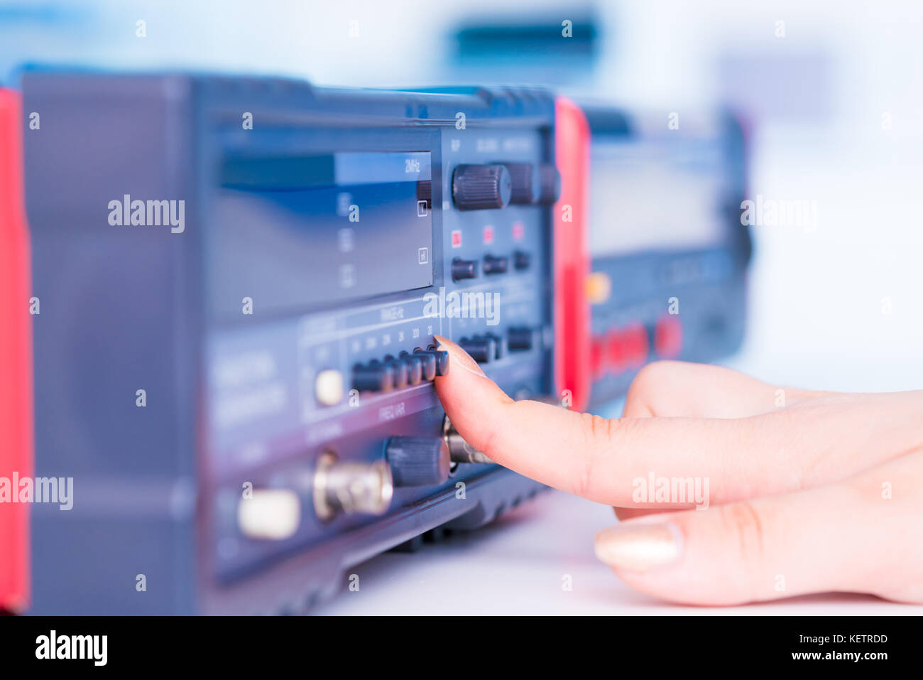 woman presses a button on an electronic measuring instrument Stock ...