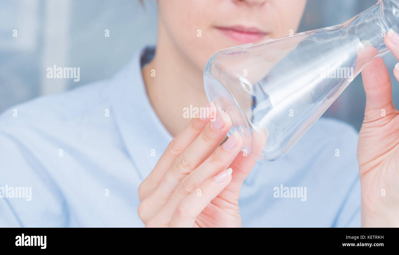 student girl with glass empty Conical flask in hand Stock Photo - Alamy