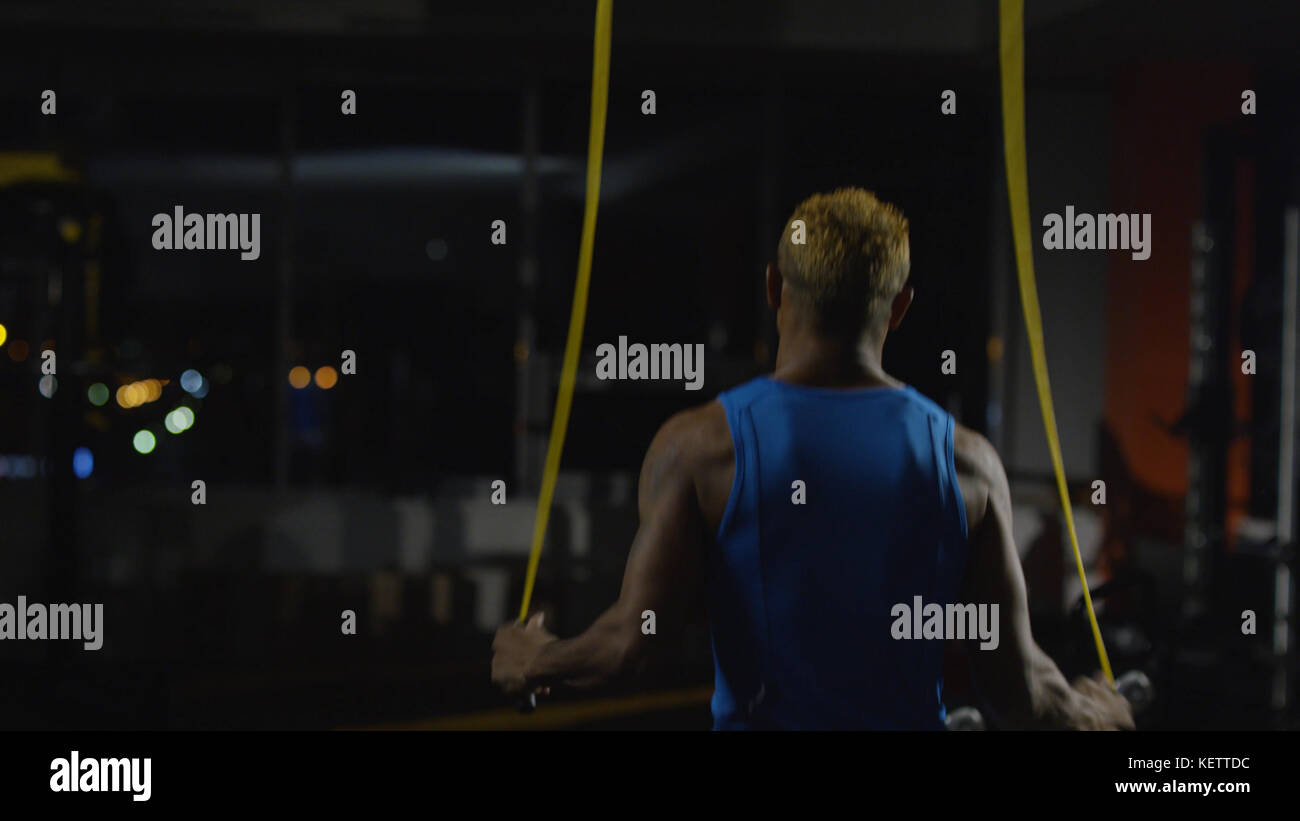 Full length portrait of a boxer jumping with skipping rope. Athletic ...