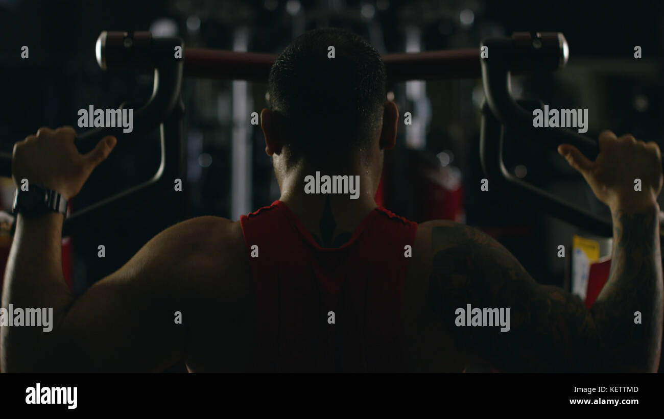 Sportsman athlete bodybuilder trains in the gym. Handsome muscular ...