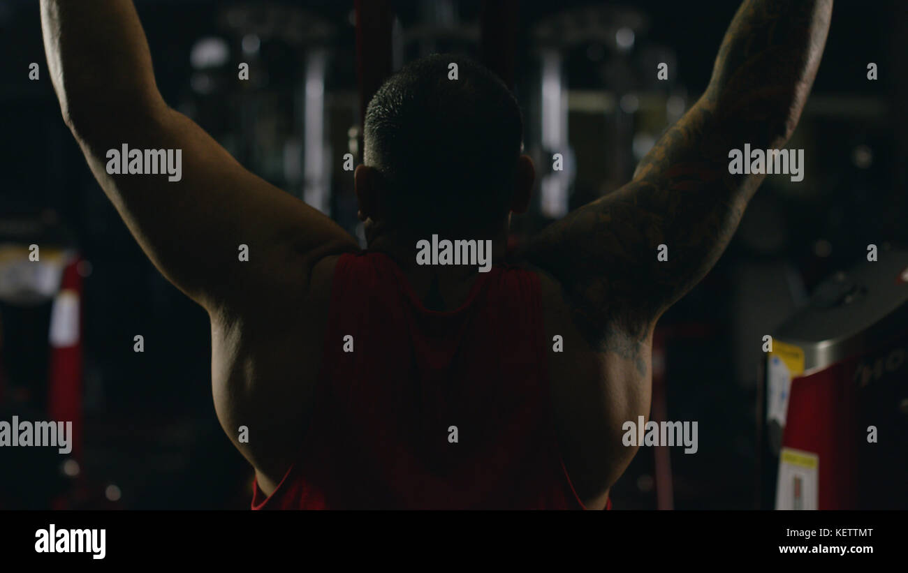 Sportsman athlete bodybuilder trains in the gym. Handsome muscular ...