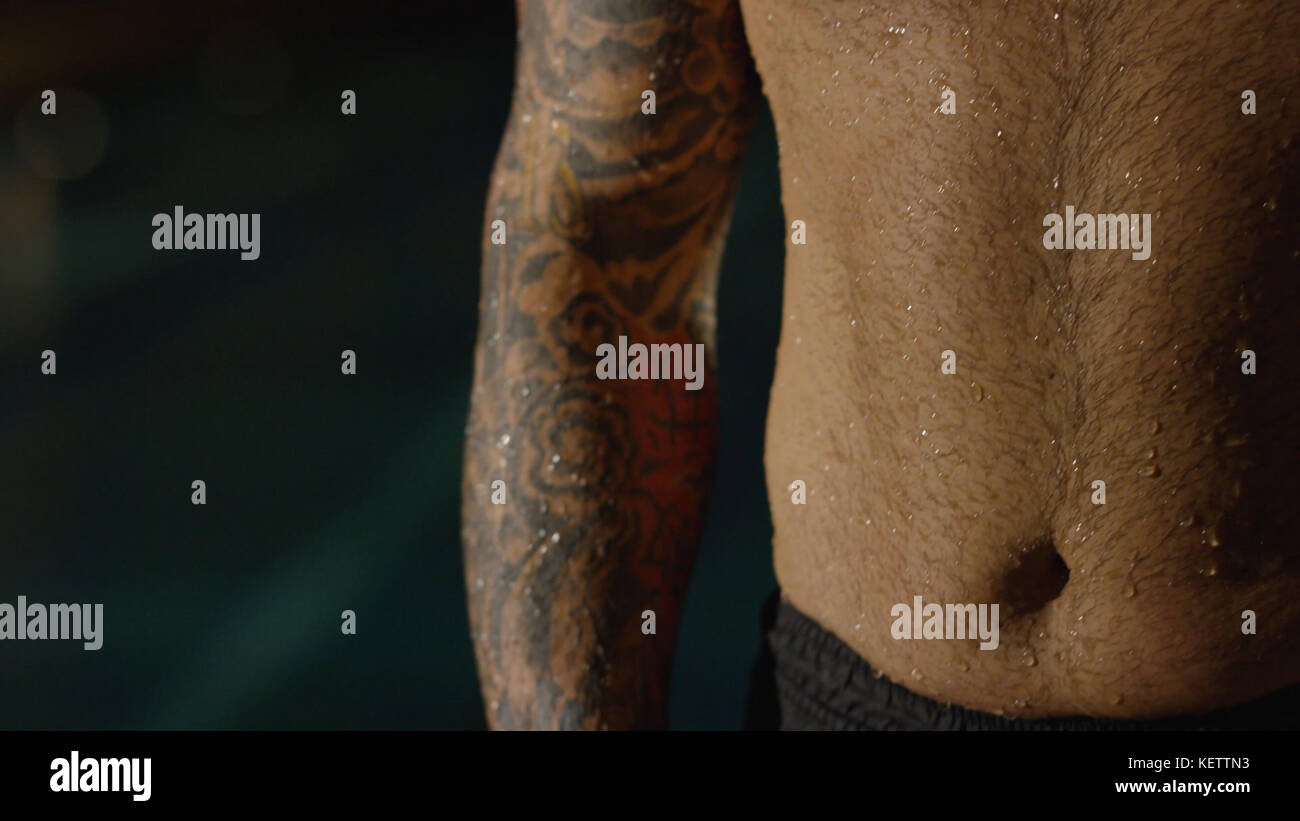 Young man in a swimming pool. Handsome swimmer. Attractive guy getting ...