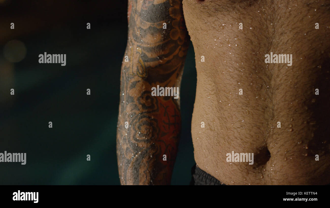 Young man in a swimming pool. Handsome swimmer. Attractive guy getting ...