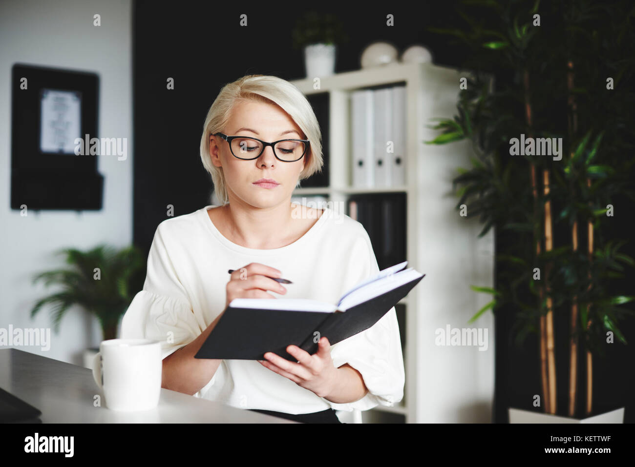 Focused student taking notes checking hi-res stock photography and ...