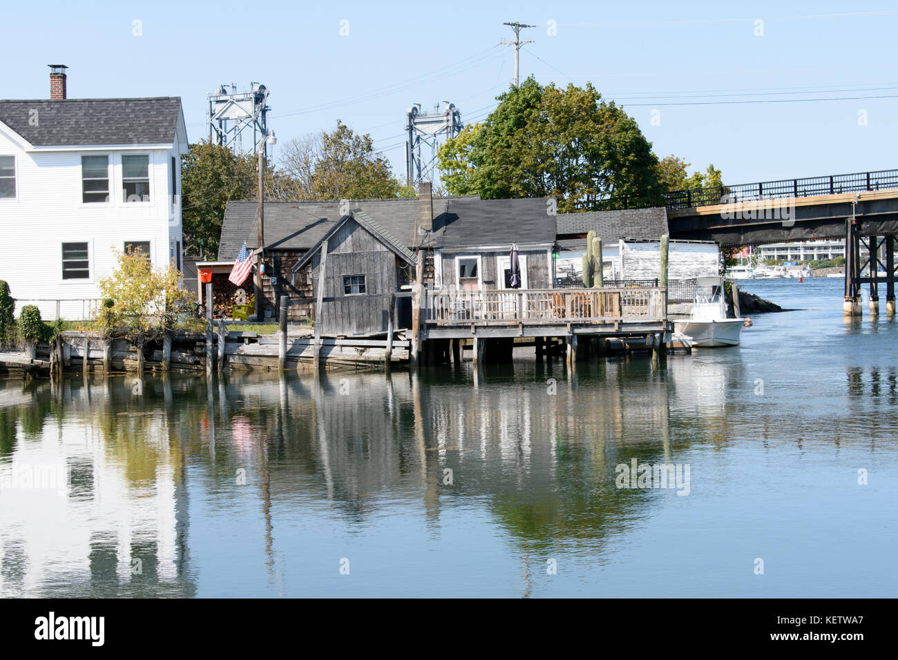House with dock and boat reflecting into the water Stock Photo - Alamy
