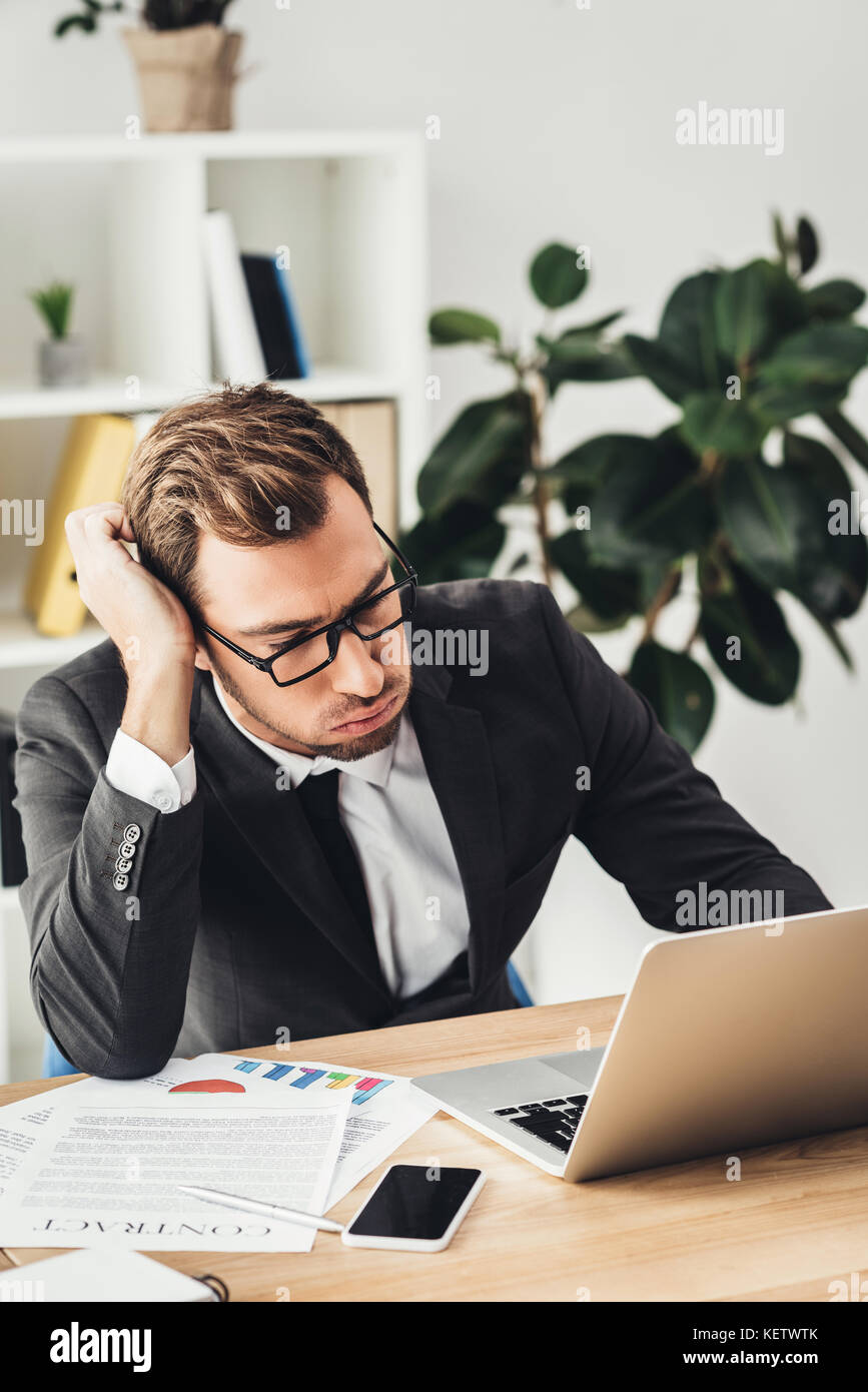 overworked businessman with laptop Stock Photo - Alamy