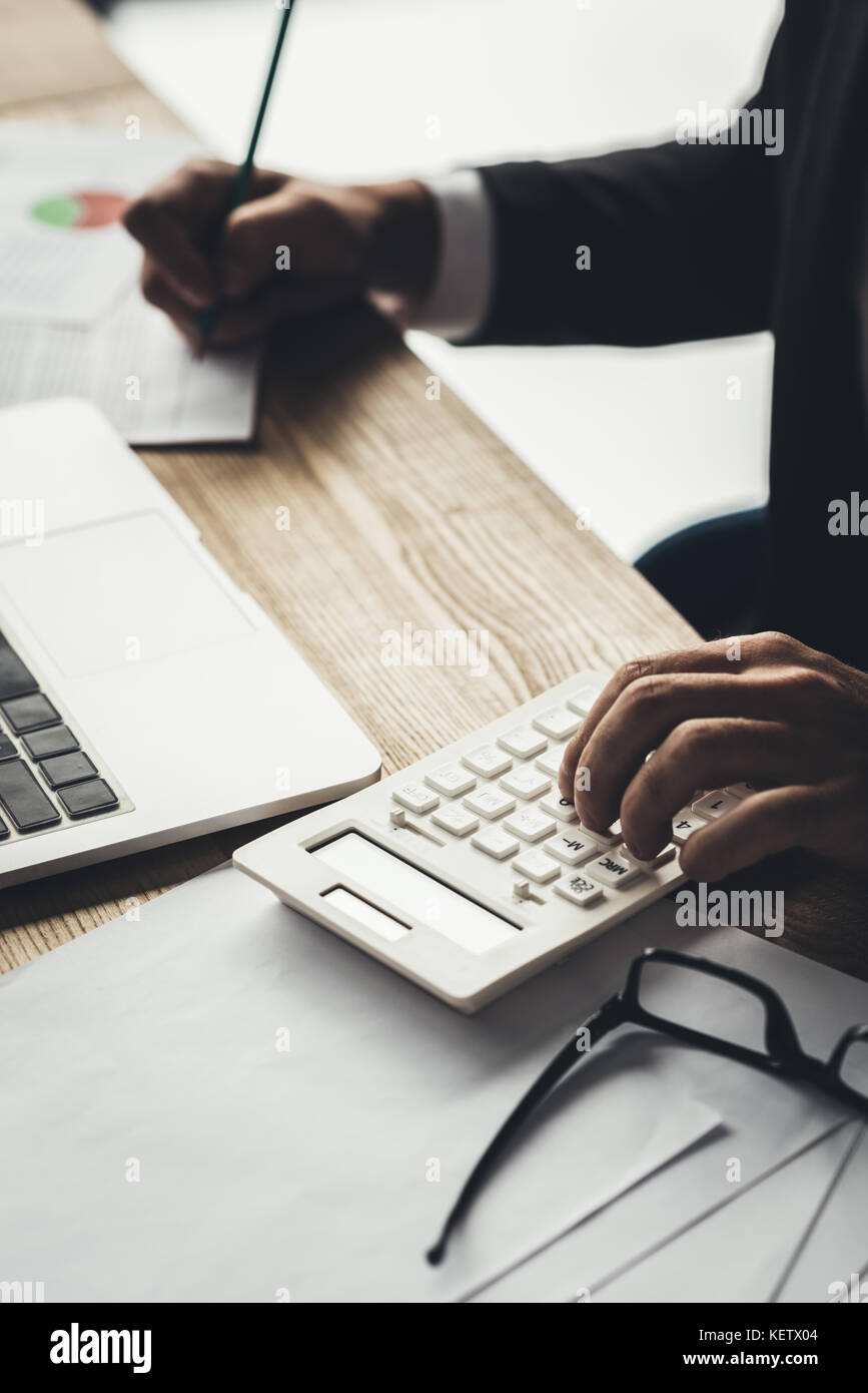 accountant using calculator Stock Photo - Alamy