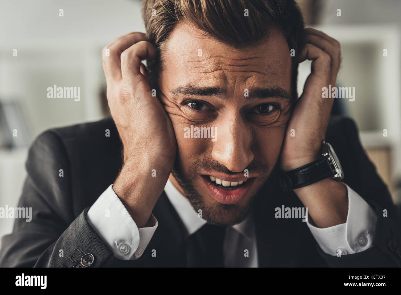 depressed businessman holding head Stock Photo - Alamy