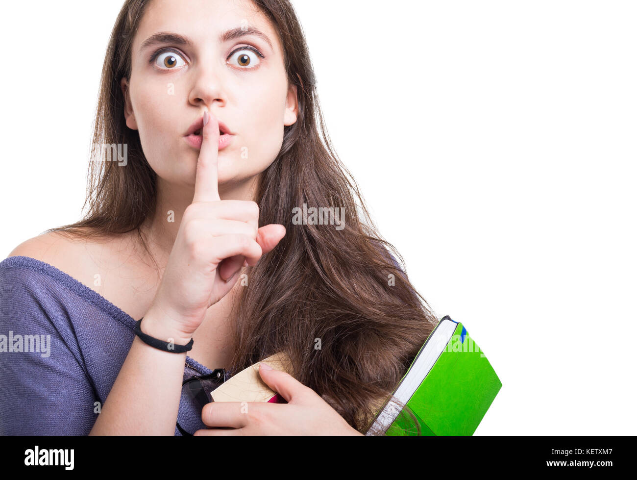 Beautiful young student doing silence or shush gesture on white ...