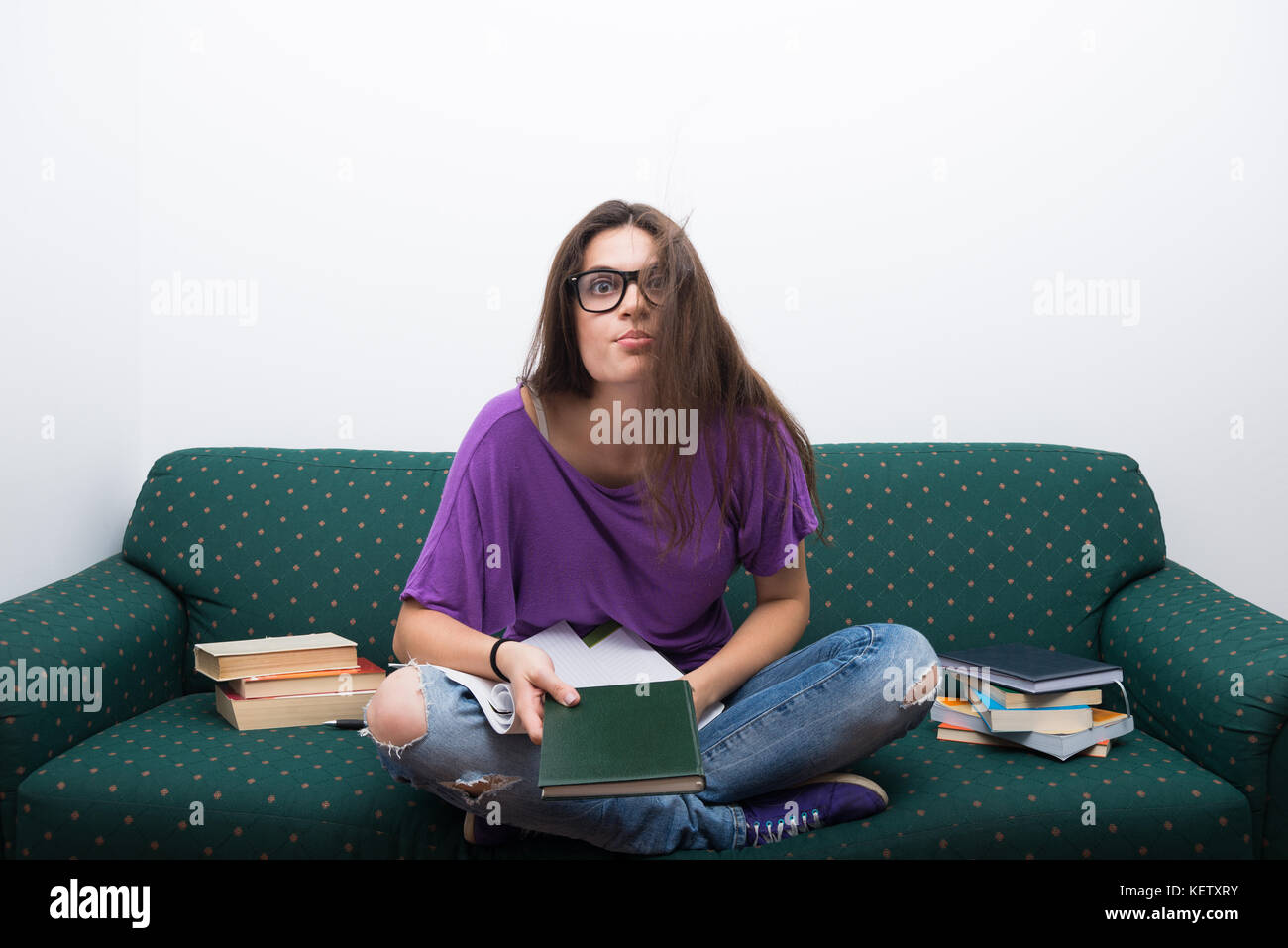 Smart college student finishing doing homework on the couch Stock Photo ...