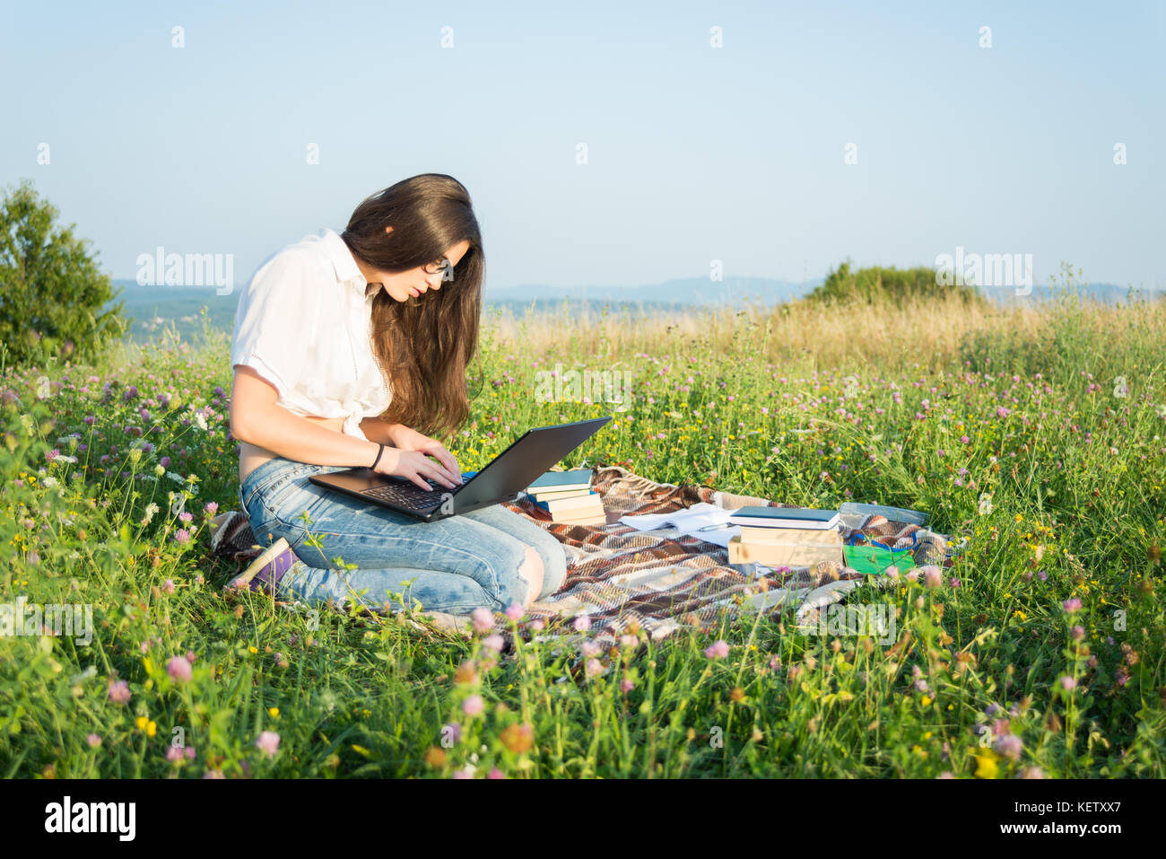 Student girl looking at the computer screen browsing on internet ...