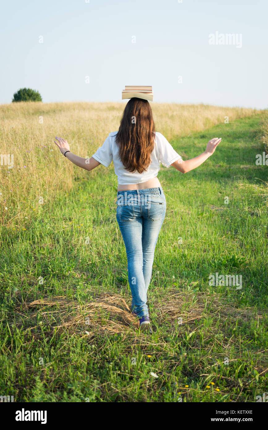 Woman balancing books head hi-res stock photography and images - Alamy