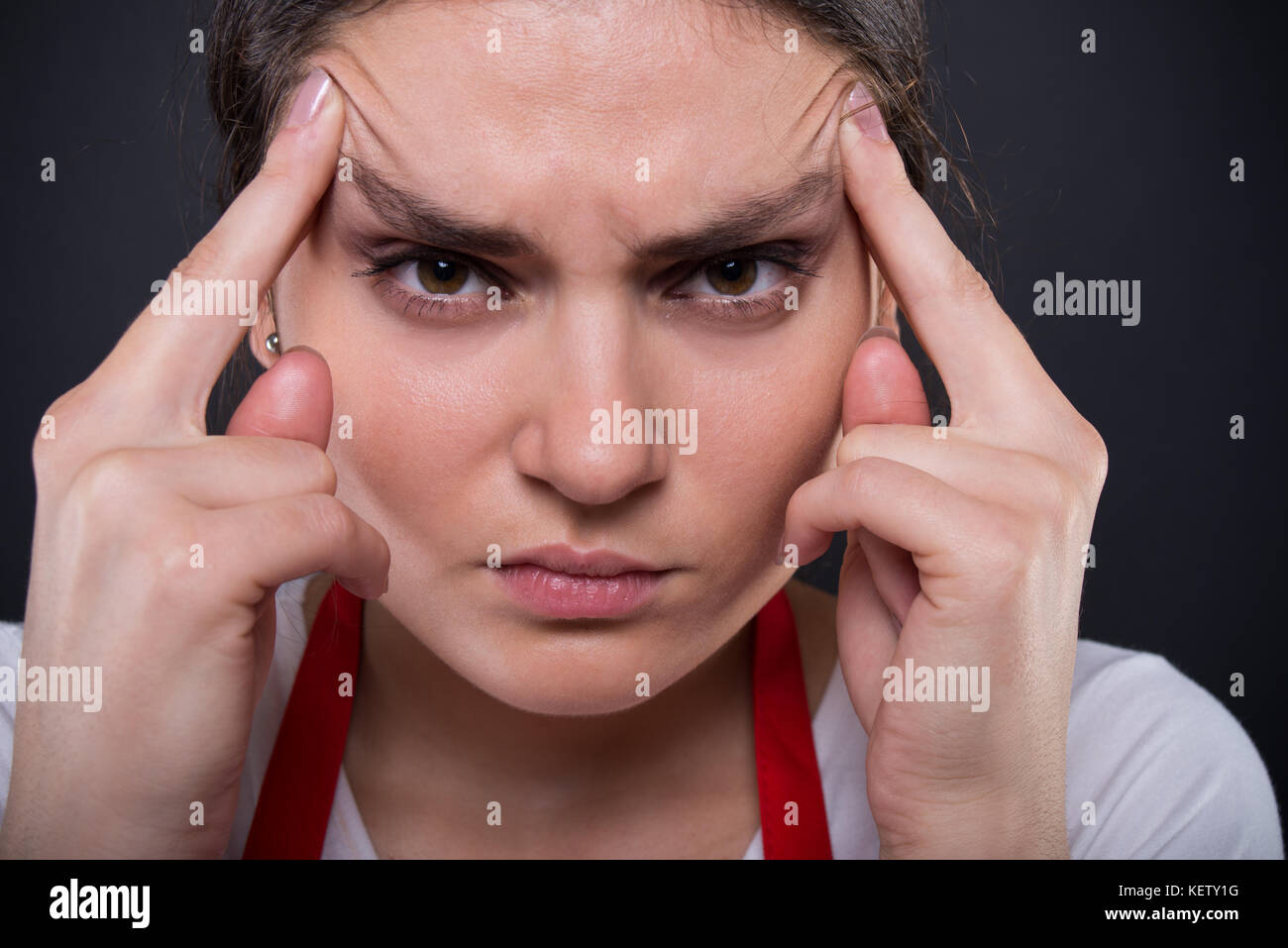 Stressed young employee in close-up view suffering from headache Stock ...