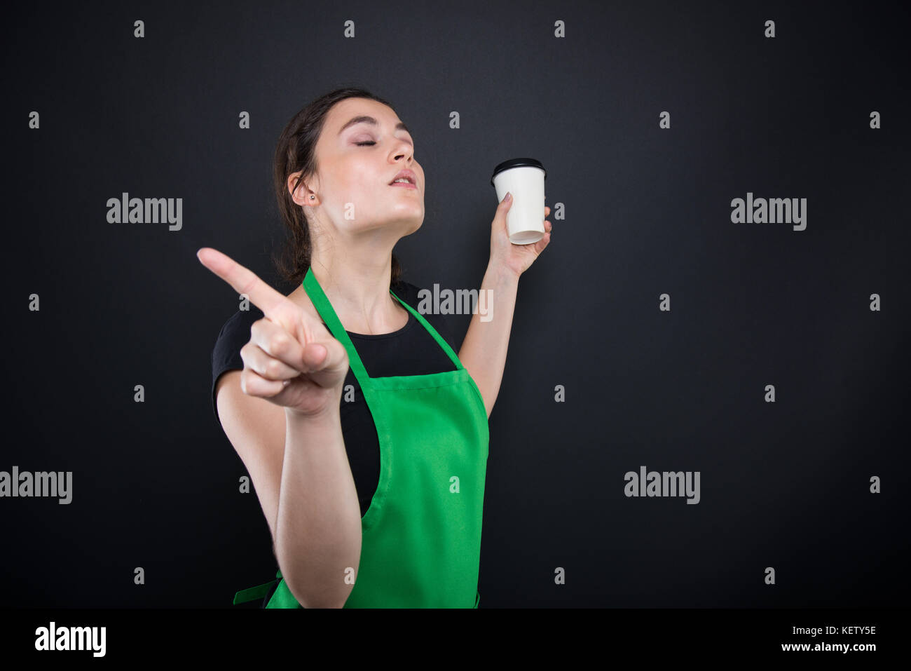 Young girl employee refusing to give you some coffee isolated on black ...
