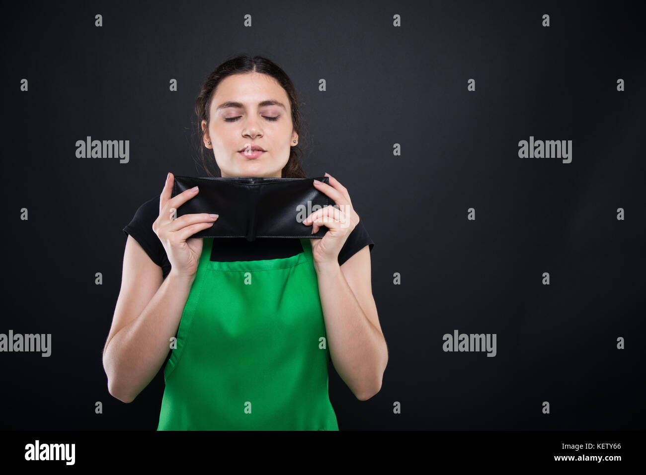 Beautiful female enjoying the smell of money after payday on dark ...