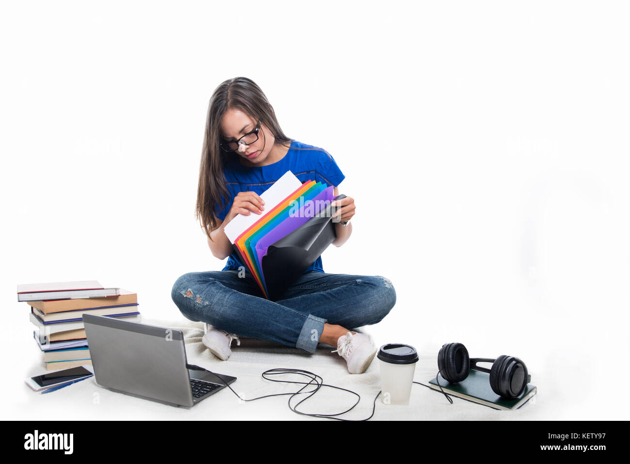 Student sitting down searching throw files with books around isolated ...