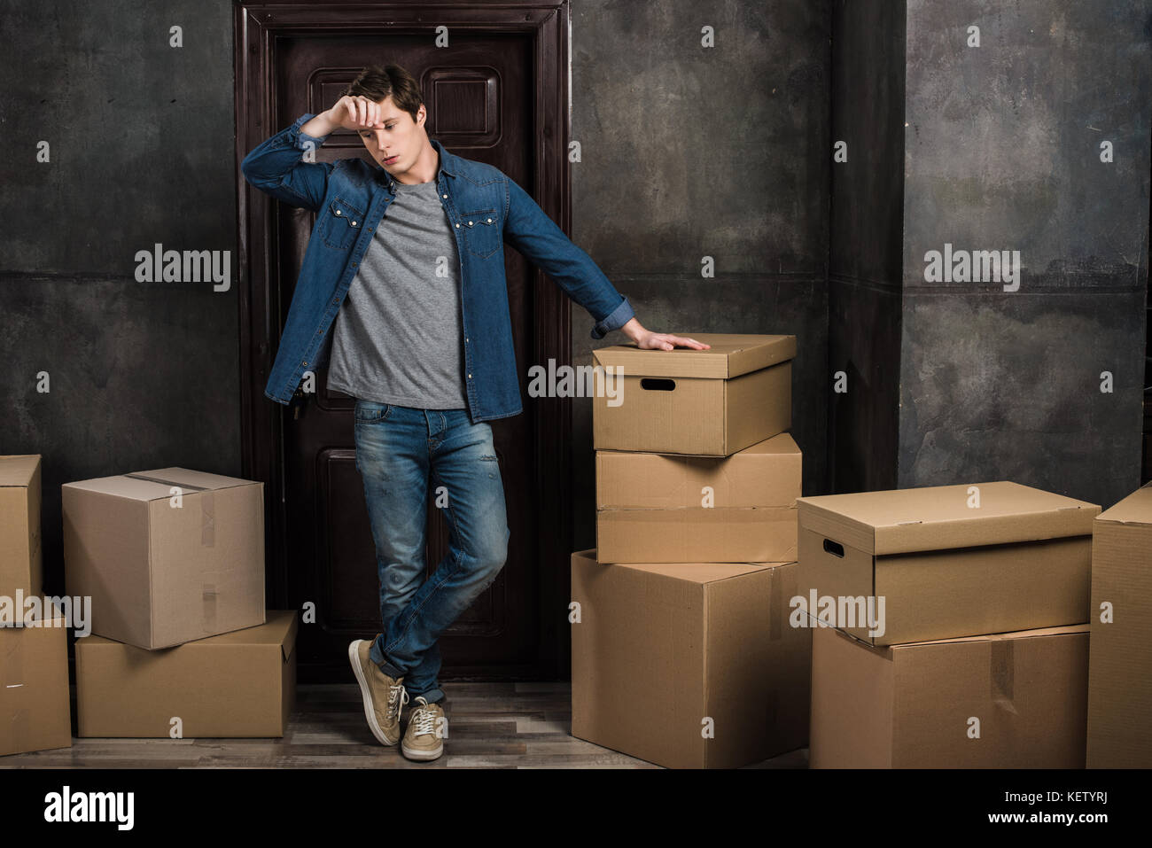 tired man at new home Stock Photo - Alamy