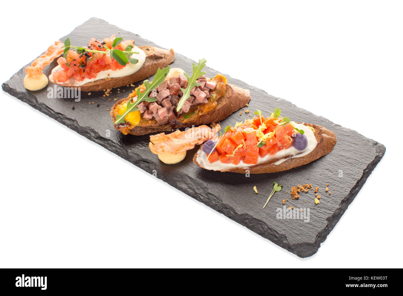 Delicious assortment of snacks on slate plate isolated Stock Photo - Alamy