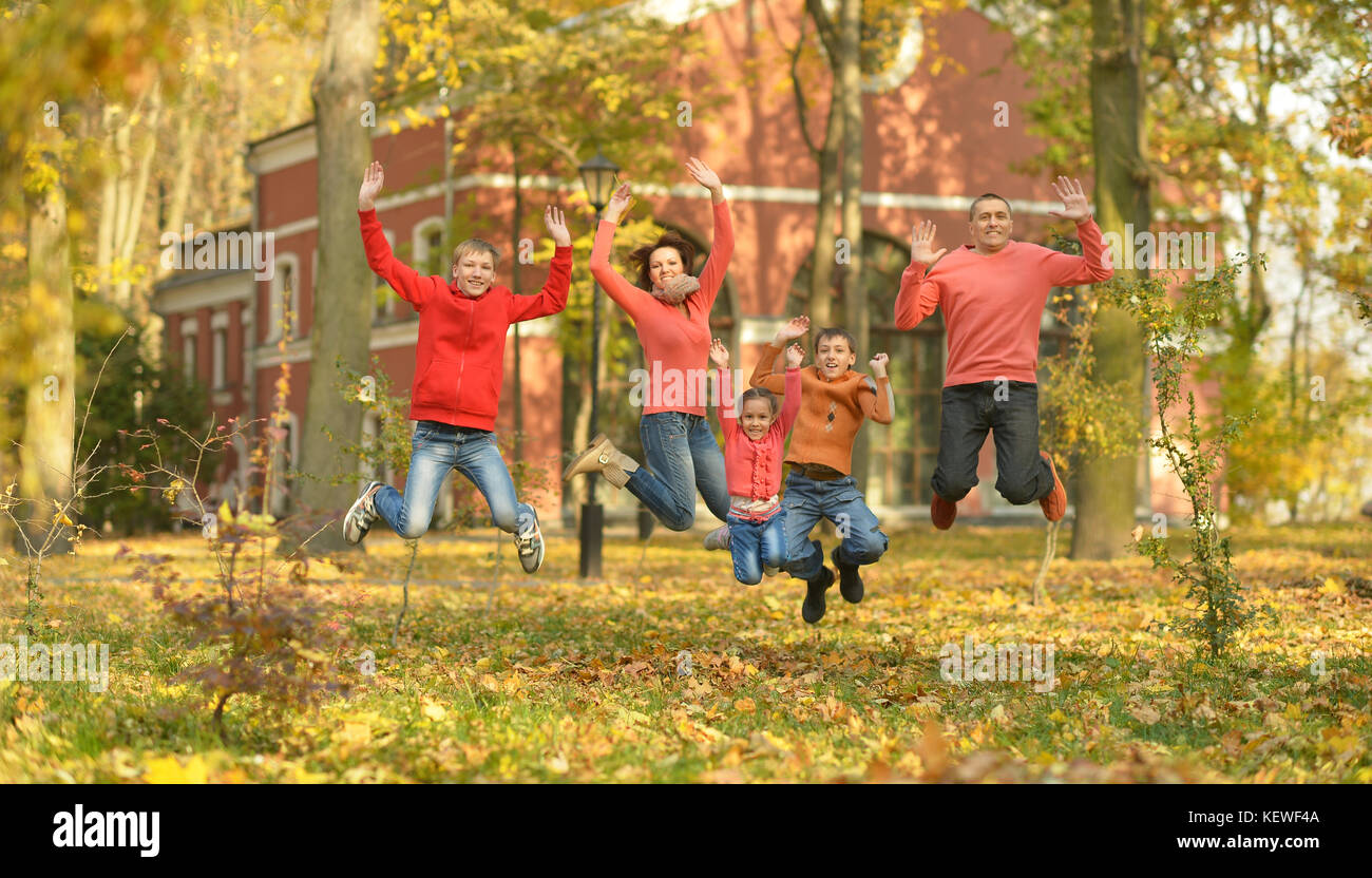 family jumping in autumn park Stock Photo - Alamy