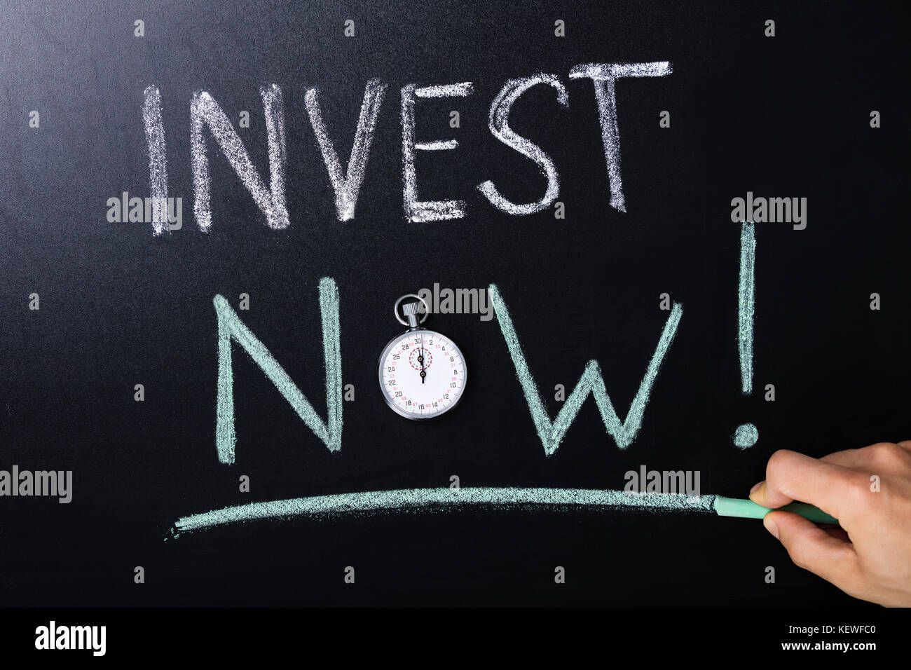 Close-up Of Invest Now Concept With Stopwatch On Blackboard Stock Photo ...