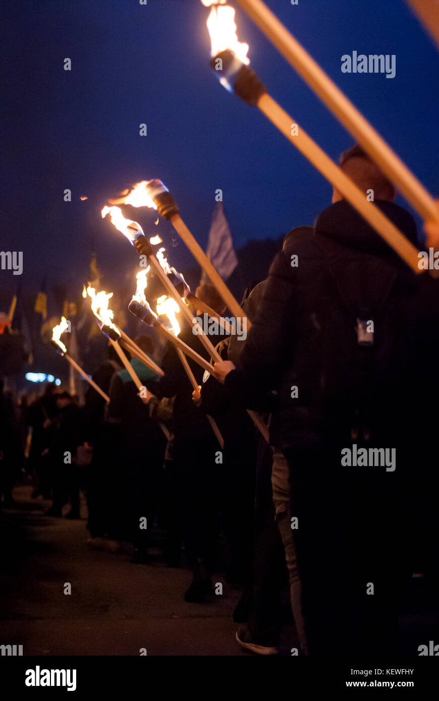 Column of people marching with torches Stock Photo - Alamy