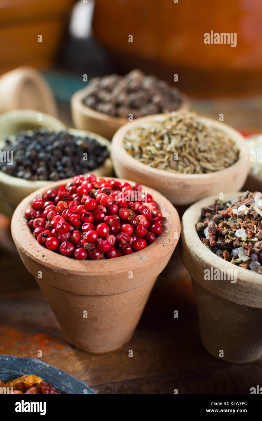 Variety of different spices with focus on pink Peruvian pepper, false ...