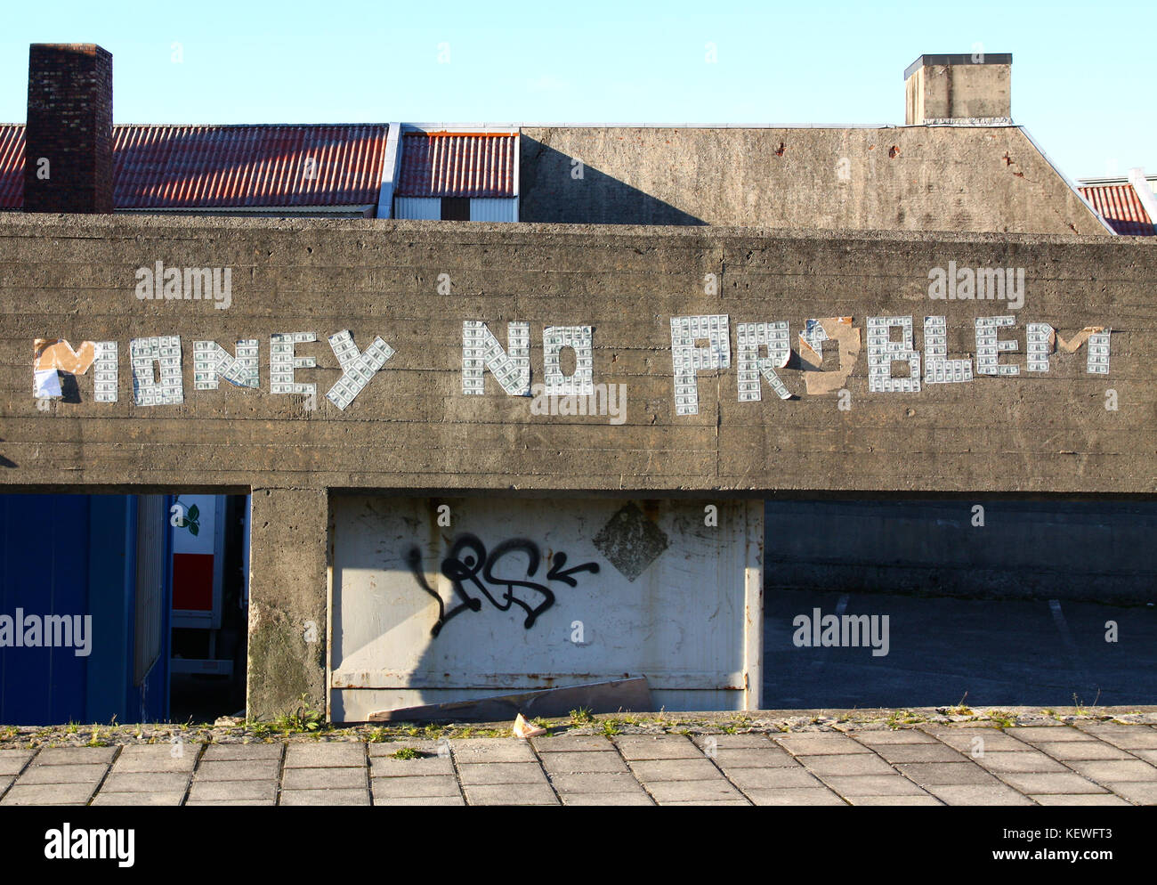 Street graffiti of dollar bills and currency spelling words 'money no ...