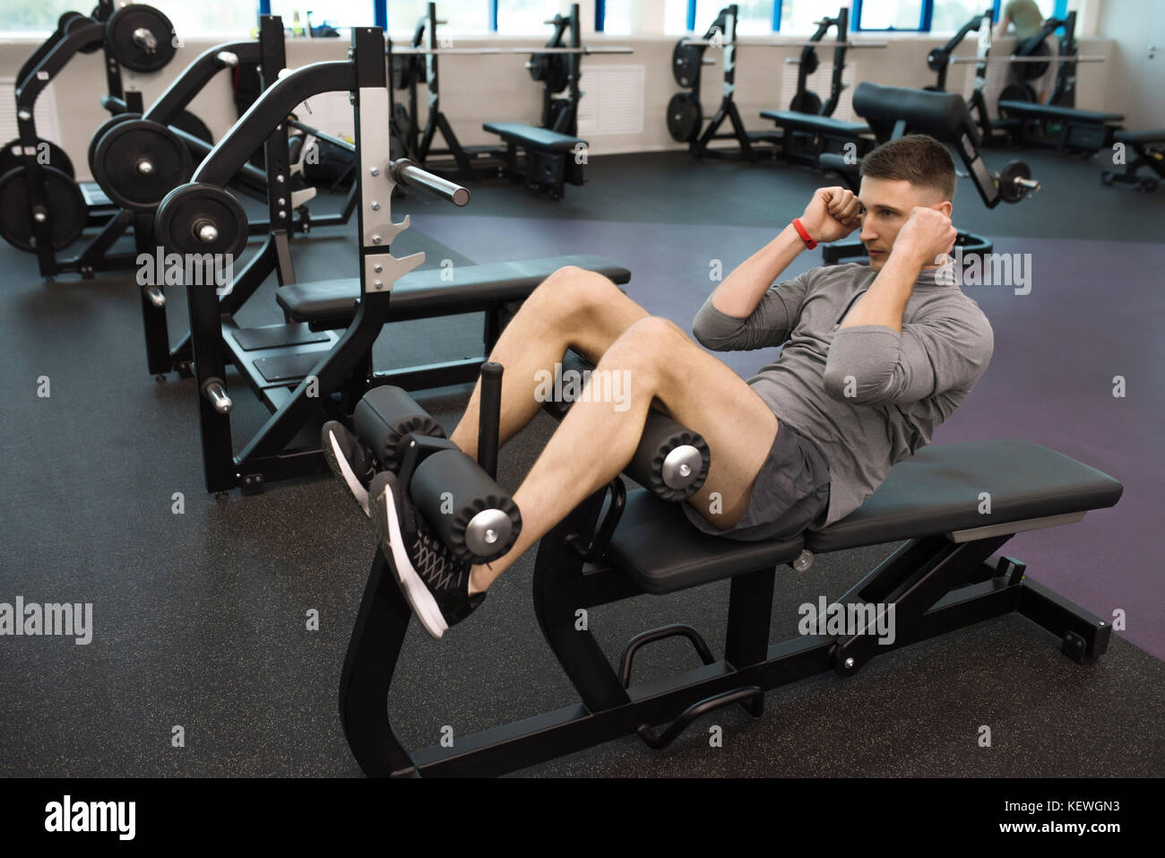 Young Man Exercising in Gym Stock Photo - Alamy